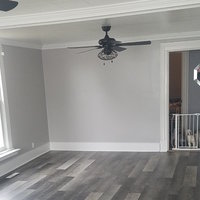 Millennial Gray / Corporate Gray paint color in an empty room.