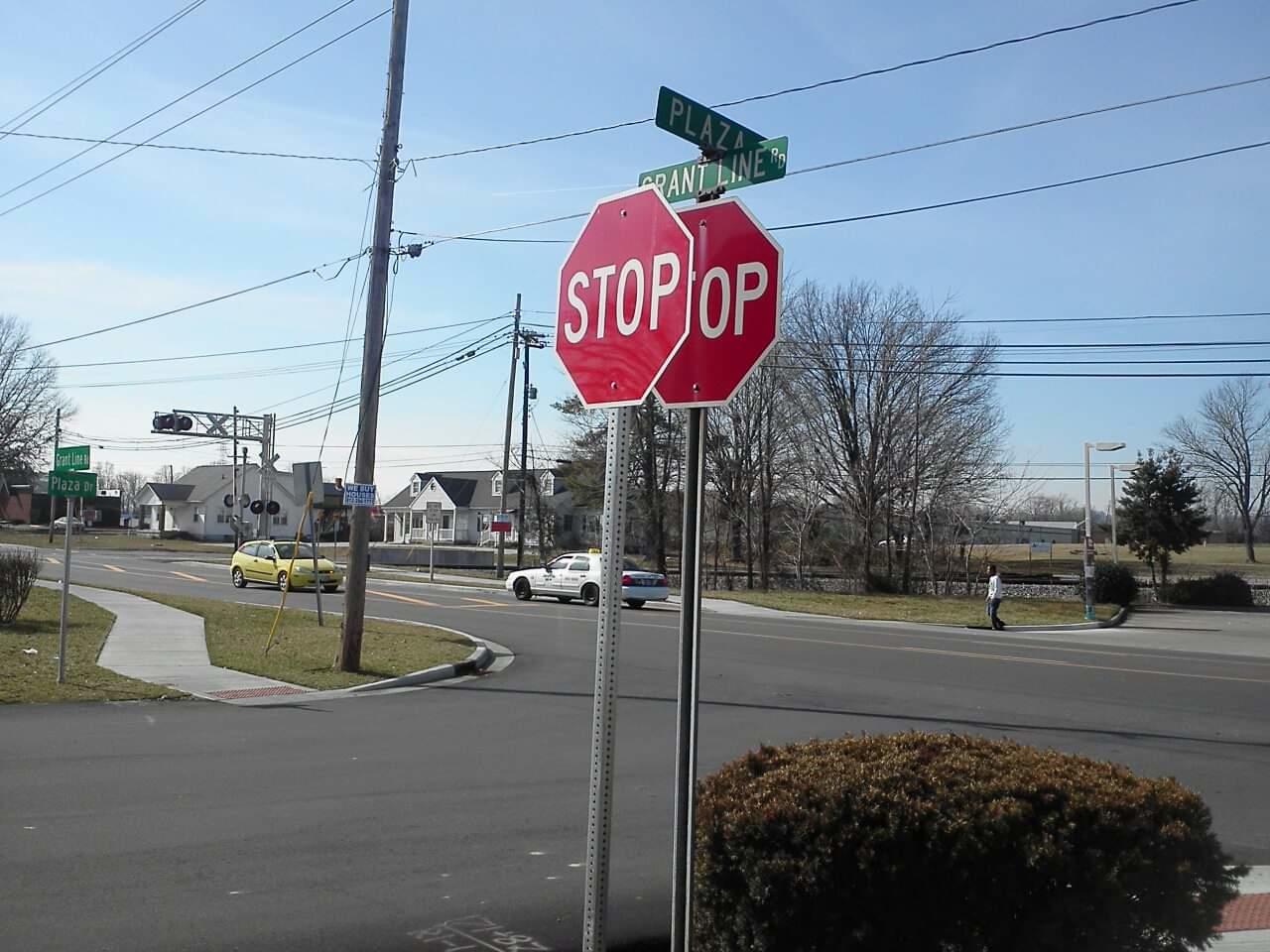 This intersection in a nearby town has two stop signs a few inches ...