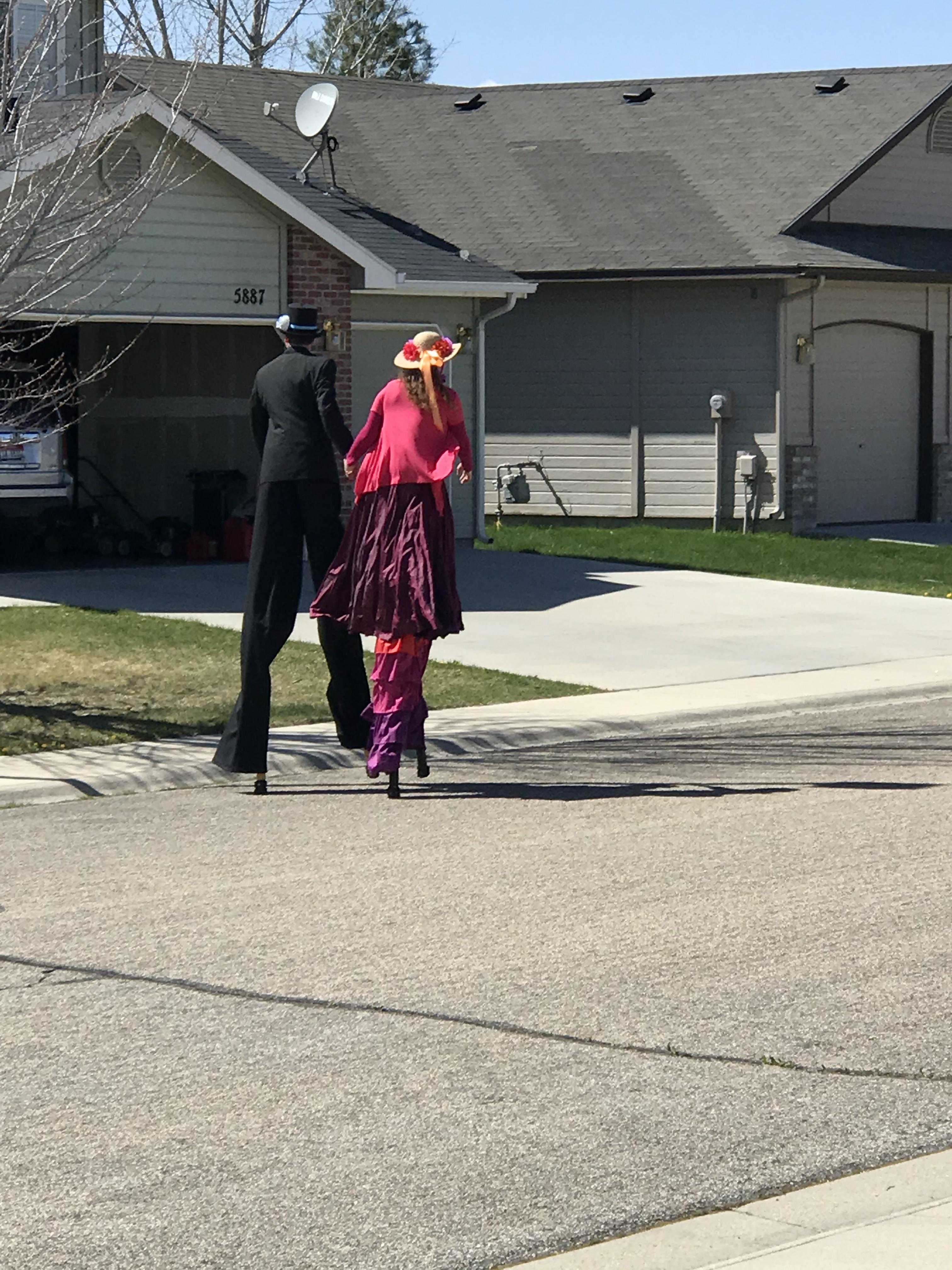 Saw a couple in period clothes walking around my neighborhood on stilts ...