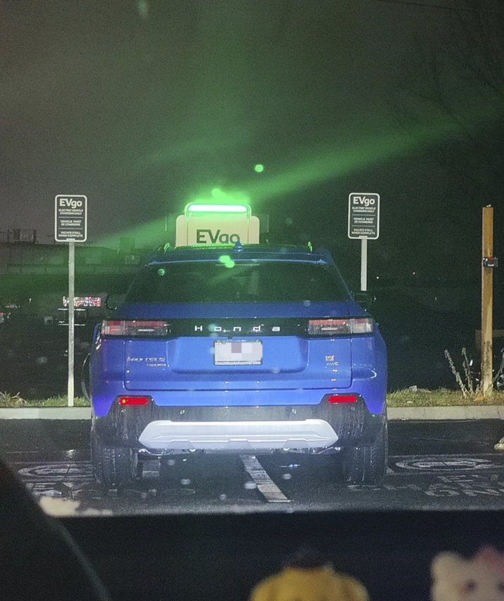 Car taking up two spots at the EV charger | Know Your Meme