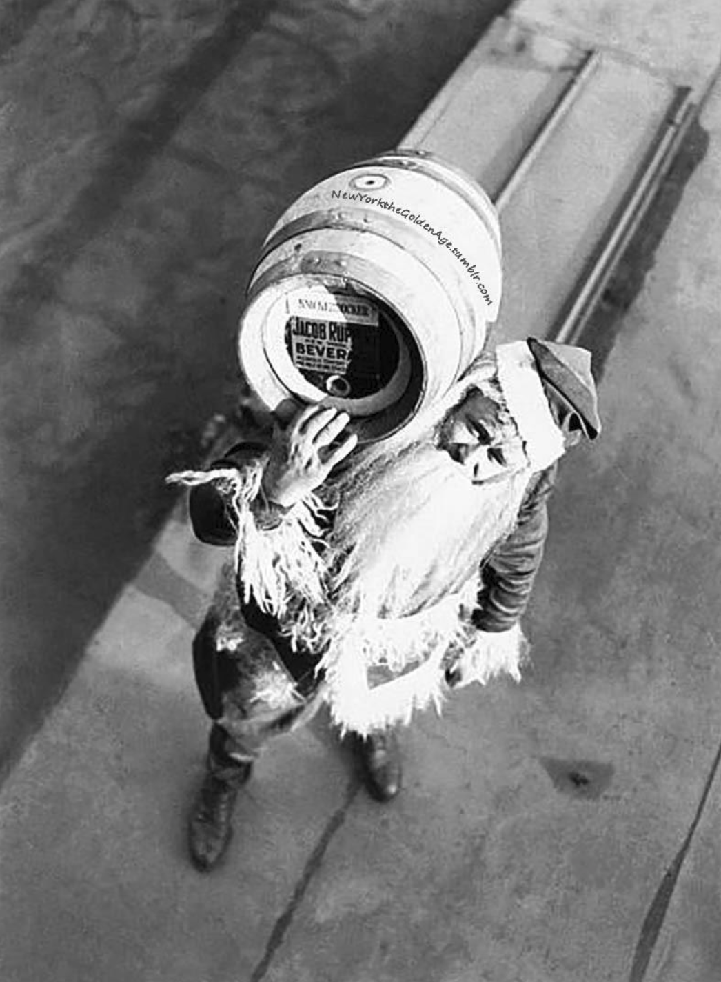 A man in a Santa costume carrying a keg of beer, 1932 | Know Your Meme