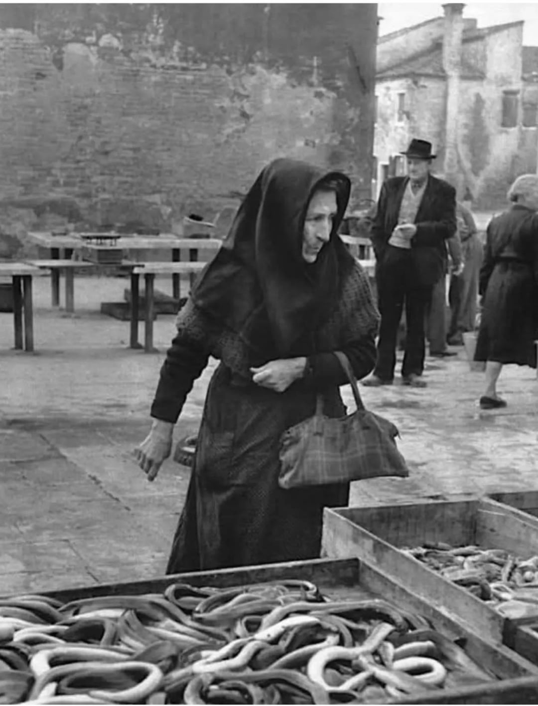 A woman at a market in Venice, 1955 | Know Your Meme